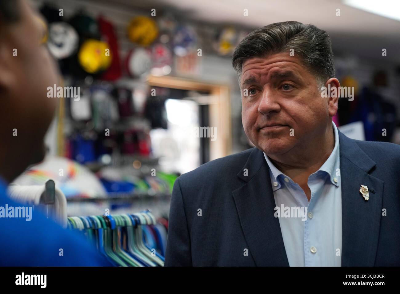 Illinois Gov. J.B. Pritzker, right, speaks with Leonel Tovar at his ...