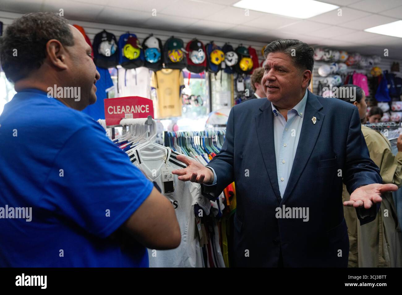 Illinois Gov. J.B. Pritzker, right, speaks with Leonel Tovar at his ...