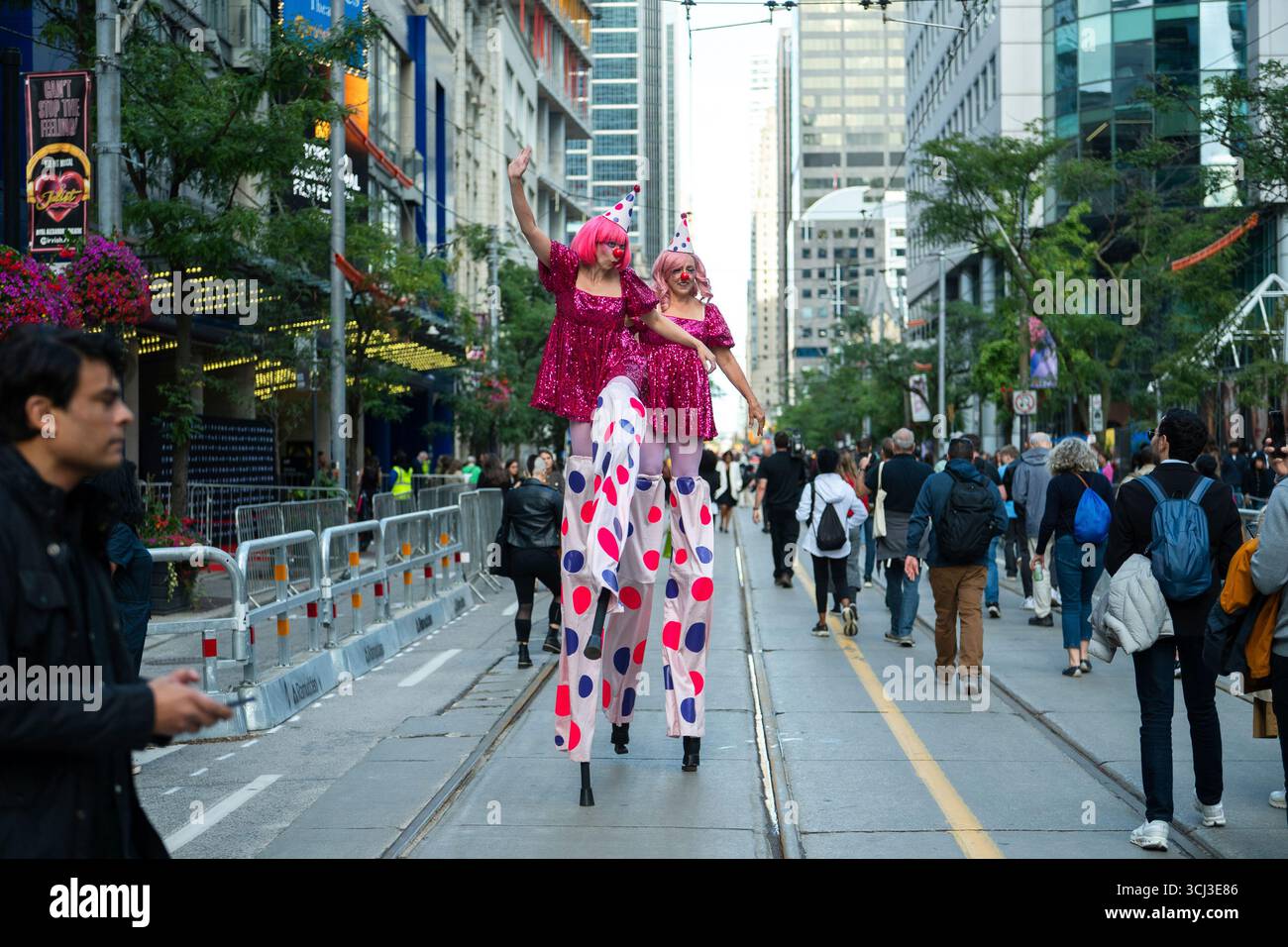 Performers on stilts walk down the street at the Toronto International ...