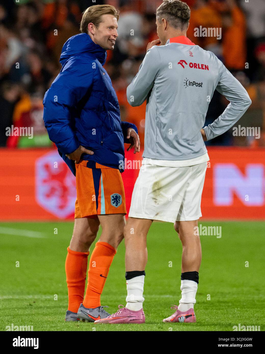 Frenkie de Jong of Netherlands talks to Robert Lewandowski of Poland ...