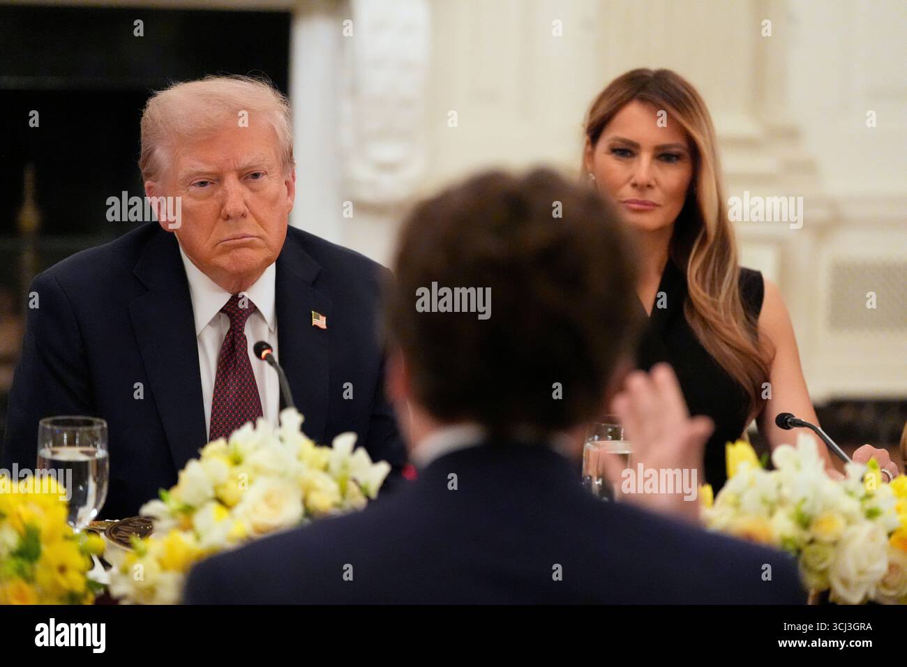President Donald Trump and first lady Melania Trump listen during a ...