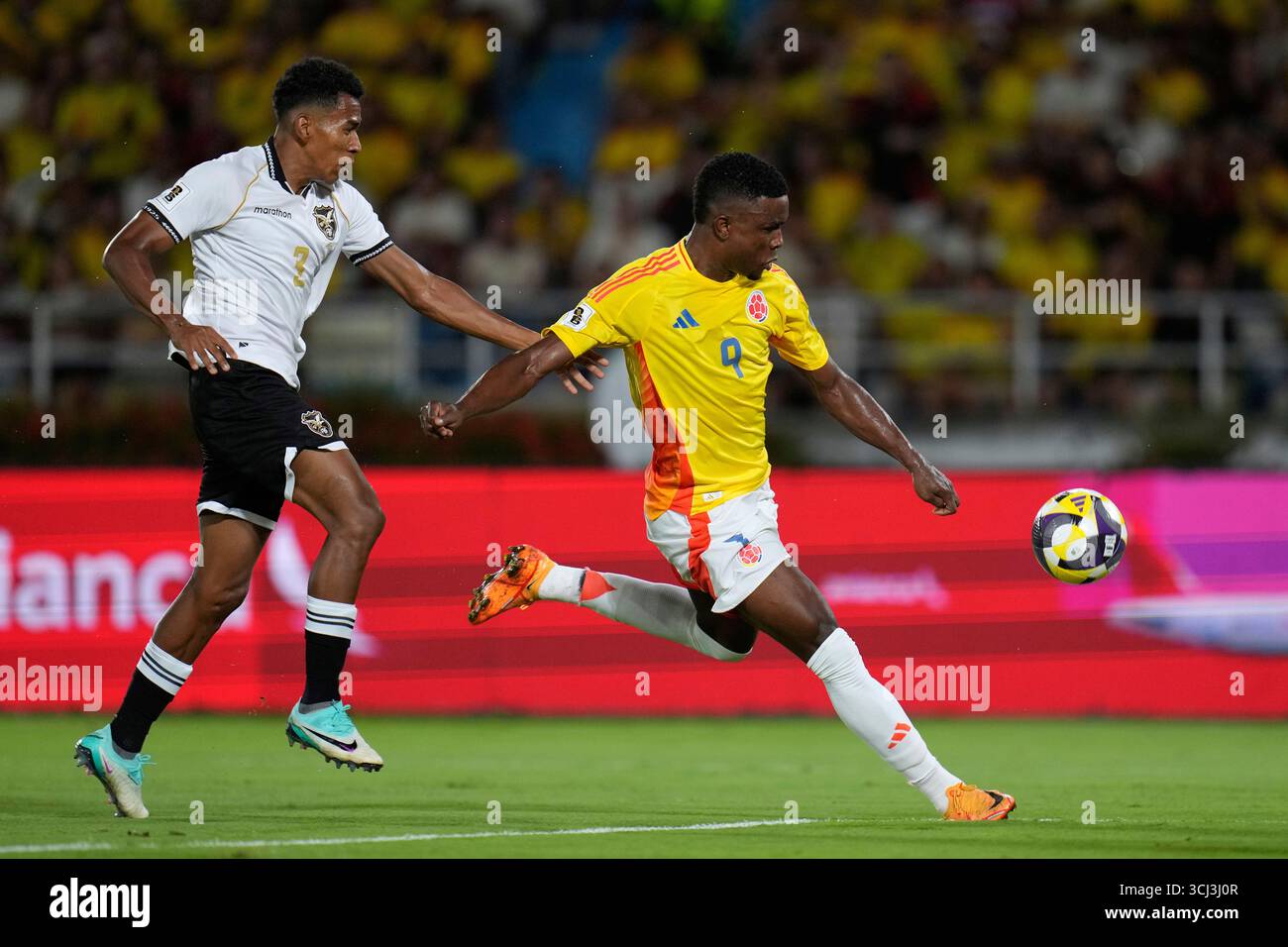 Colombia's Jhon Cordoba prepares to take a shot challenged by Bolivia's ...