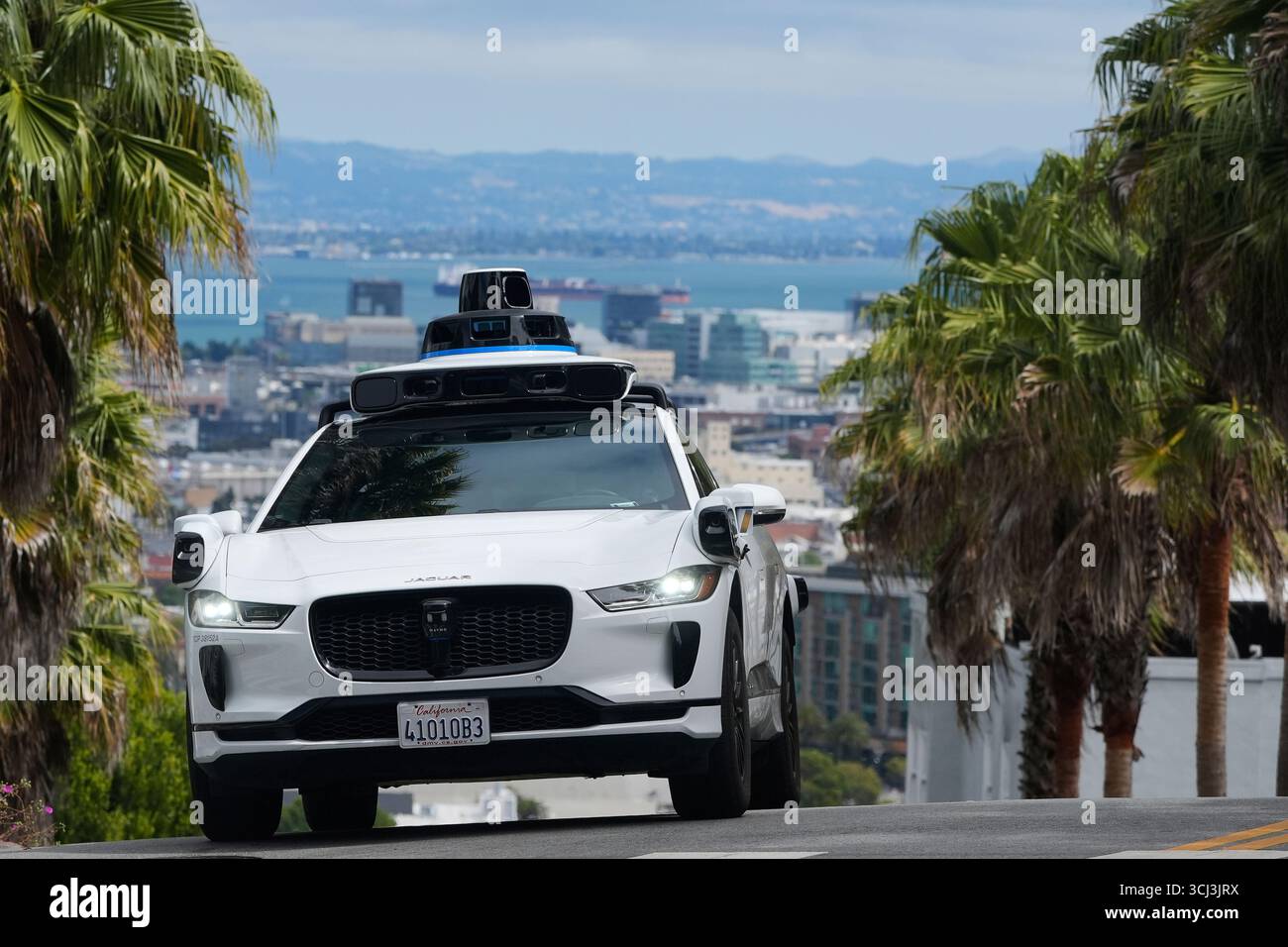 A Waymo car drives up a hill in San Francisco, Thursday, Sept. 4, 2025 ...