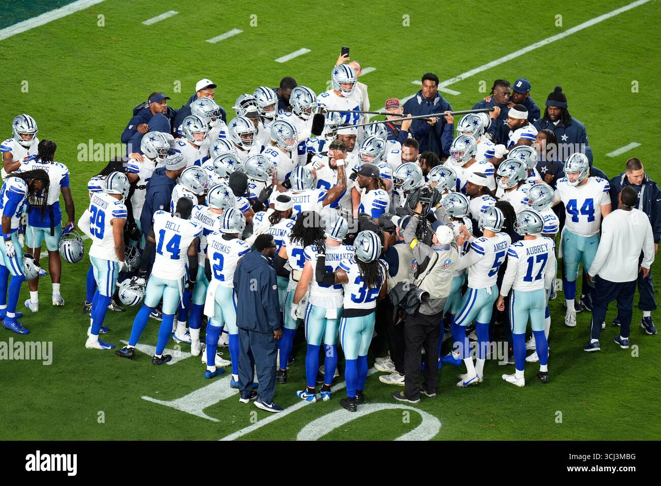 The Dallas Cowboys huddle on the field before an NFL football game ...