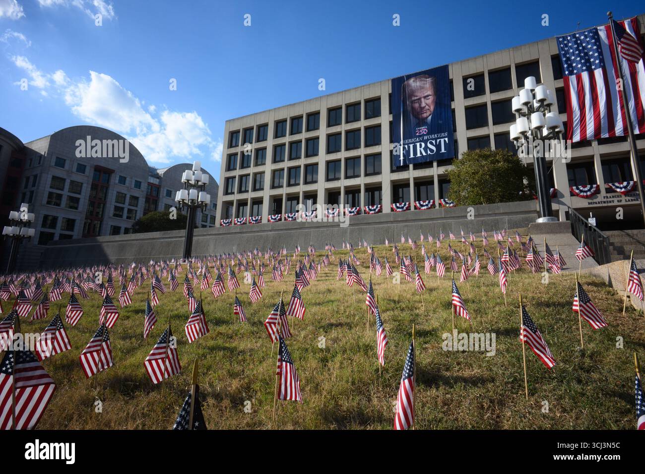 A banner with a portrait of President Donald Trump hangs on the front ...