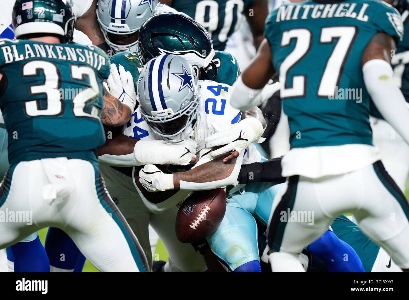 Dallas Cowboys running back Miles Sanders fumbles the ball in as Philadelphia Eagles' Reed ...
