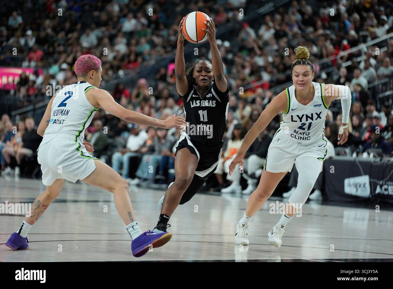 Las Vegas Aces guard Dana Evans (11) drives against Minnesota Lynx guard Natisha Hiedeman (2 ...