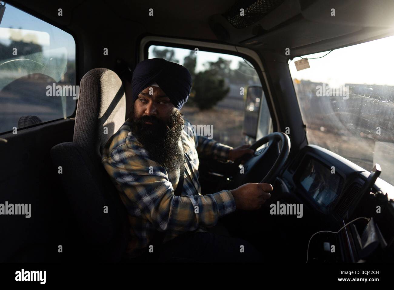Sikh truck driver Prahb Singh maneuvers his truck at a gas station in ...