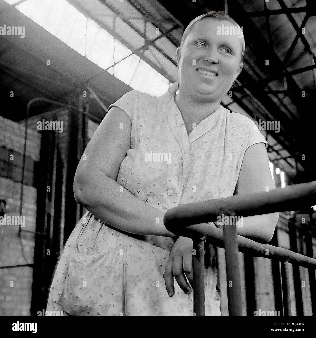 A cheerful portrait of a Soviet female worker in a summer dress ...