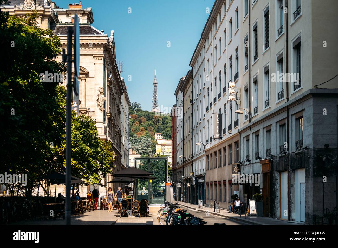Street view in central Lyon with outdoor cafes bicycles classic French ...