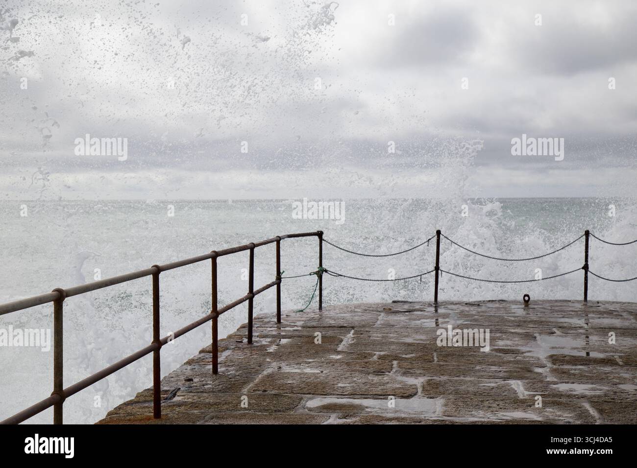 high tide overtopping flood water Port of Porthleven pier Stock Photo ...
