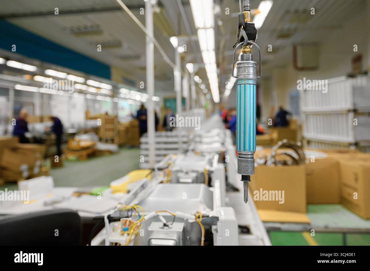 Production line showcasing a stylish hanging tool in a busy ...