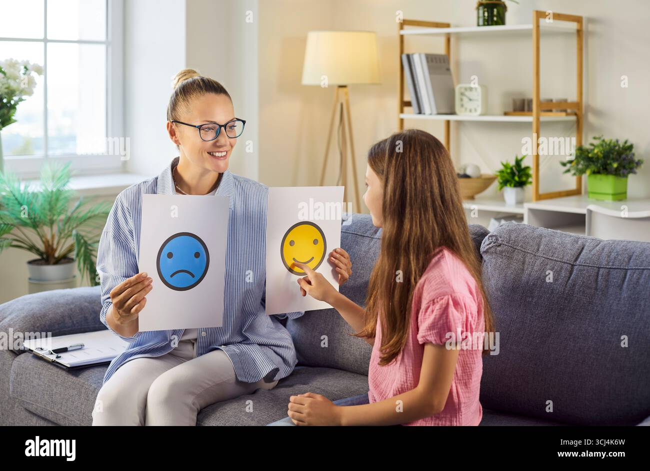 Child counseling session with psychologist using emotion cards for ...