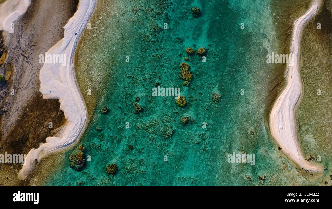 Aerial view of turquoise waters embracing the soft, sandy shores of a ...