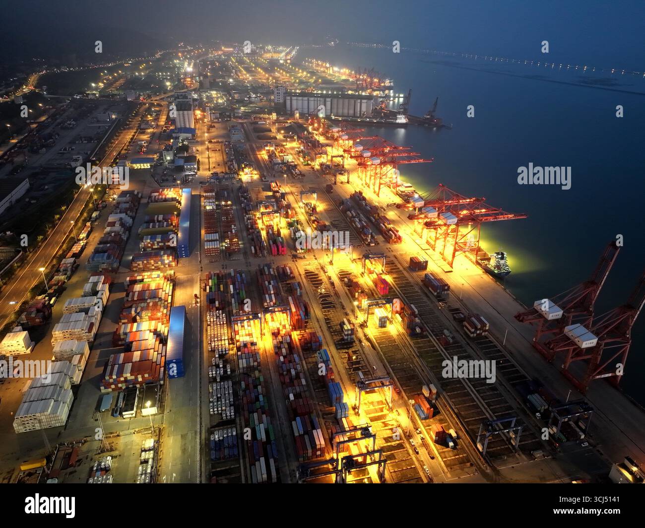 Aerial photo shows the container terminal of Lianyungang Port at night ...