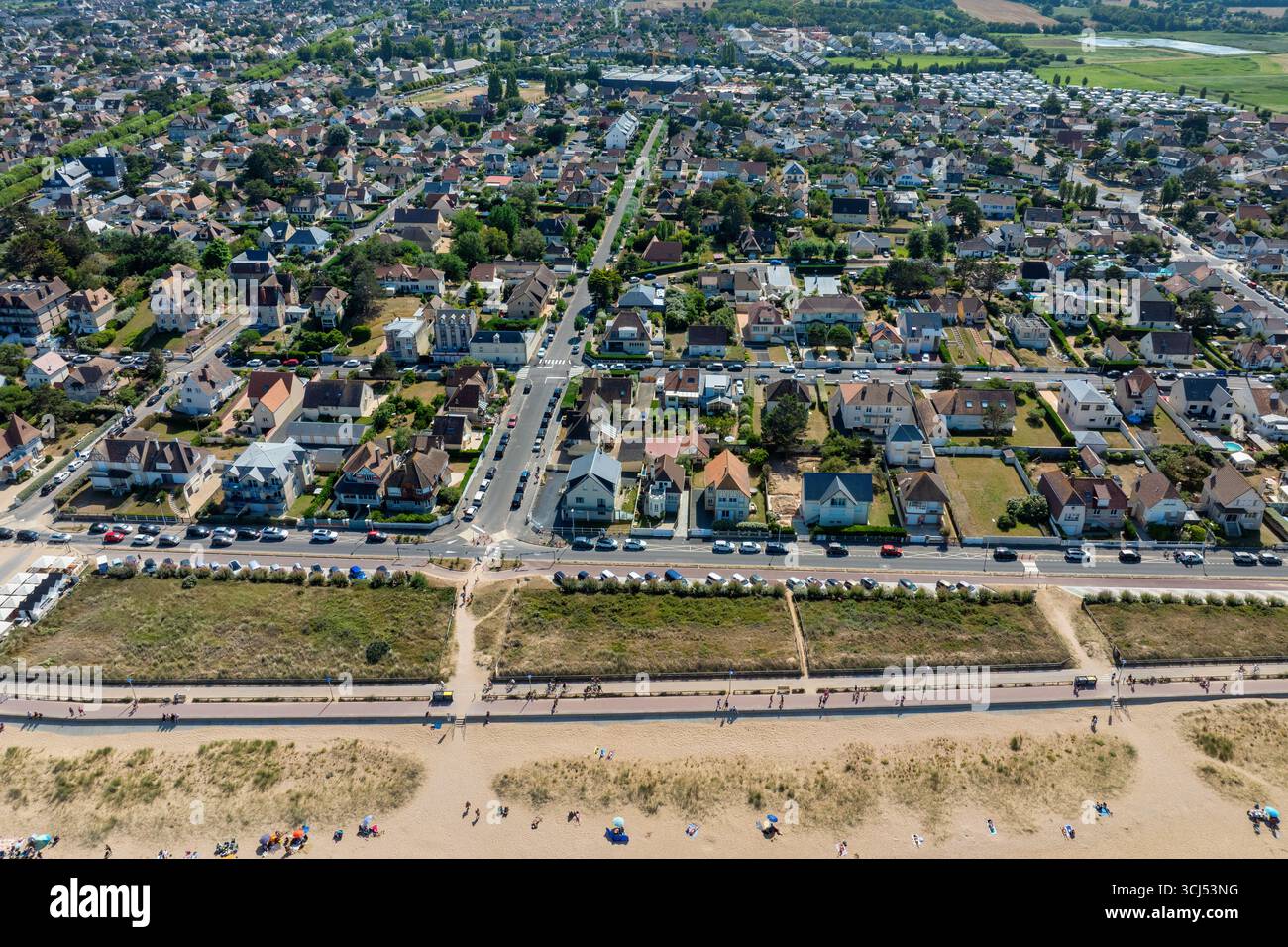 Aerial view of the expansive beach meeting the quaint town with its mix ...