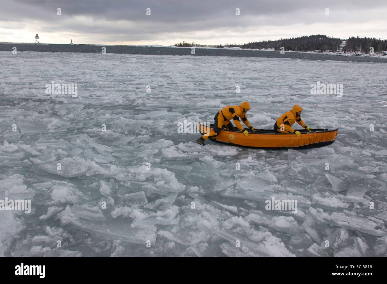 Two winter explorers training in dangerous open water and thin ice ...