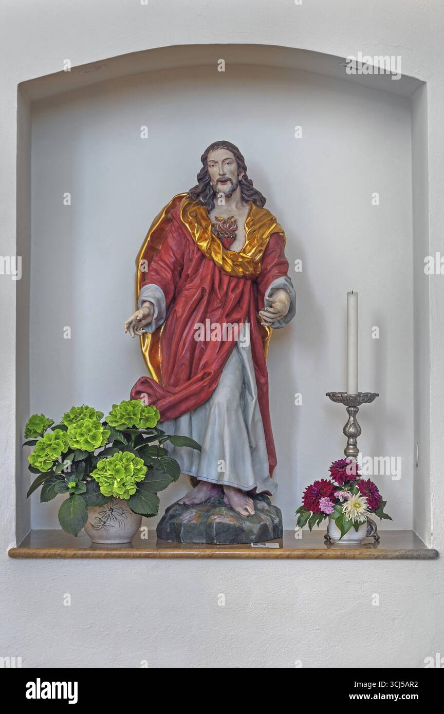 Niche with figure of Jesus, floral decoration and candle in the Roman ...