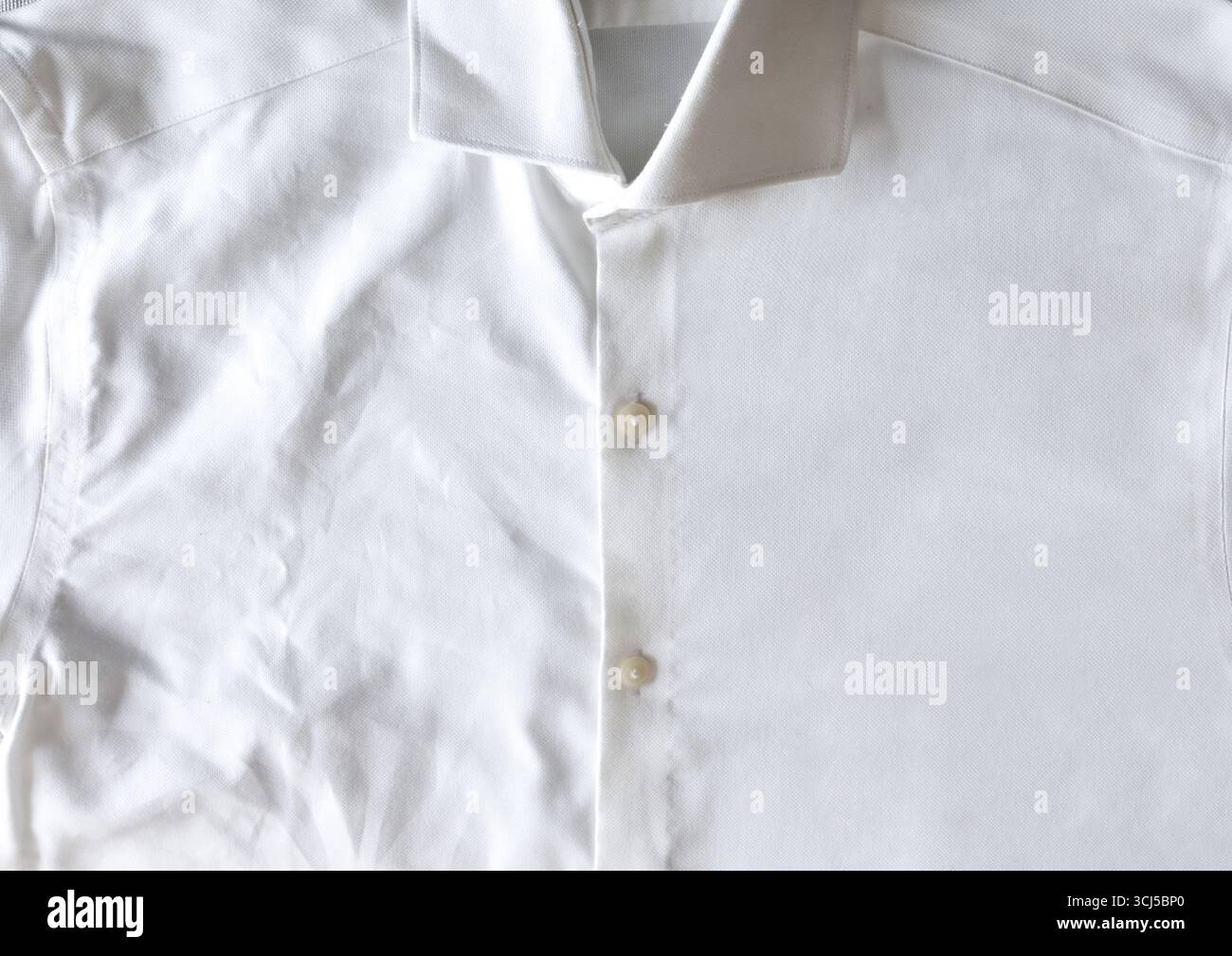 Steam ironing concept with an un-ironed, wrinkled shirt on one side and ...