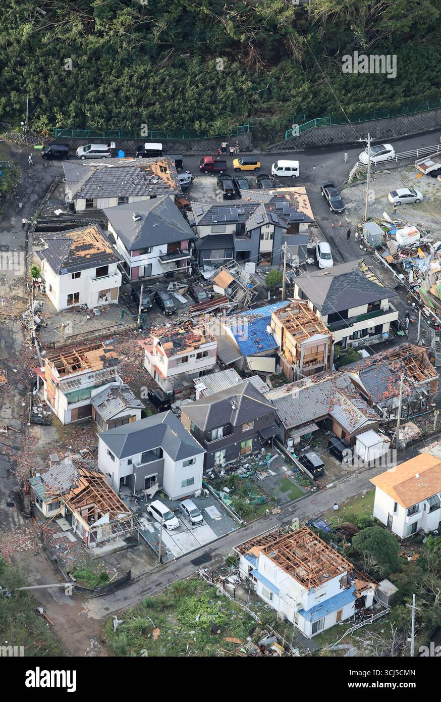 An aerial photo shows buildings damaged by a sudden gust of wind ...