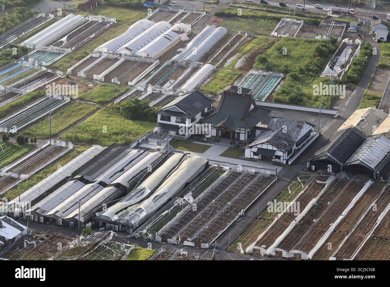 An aerial photo shows vinyl houses damaged by a sudden gust of wind ...