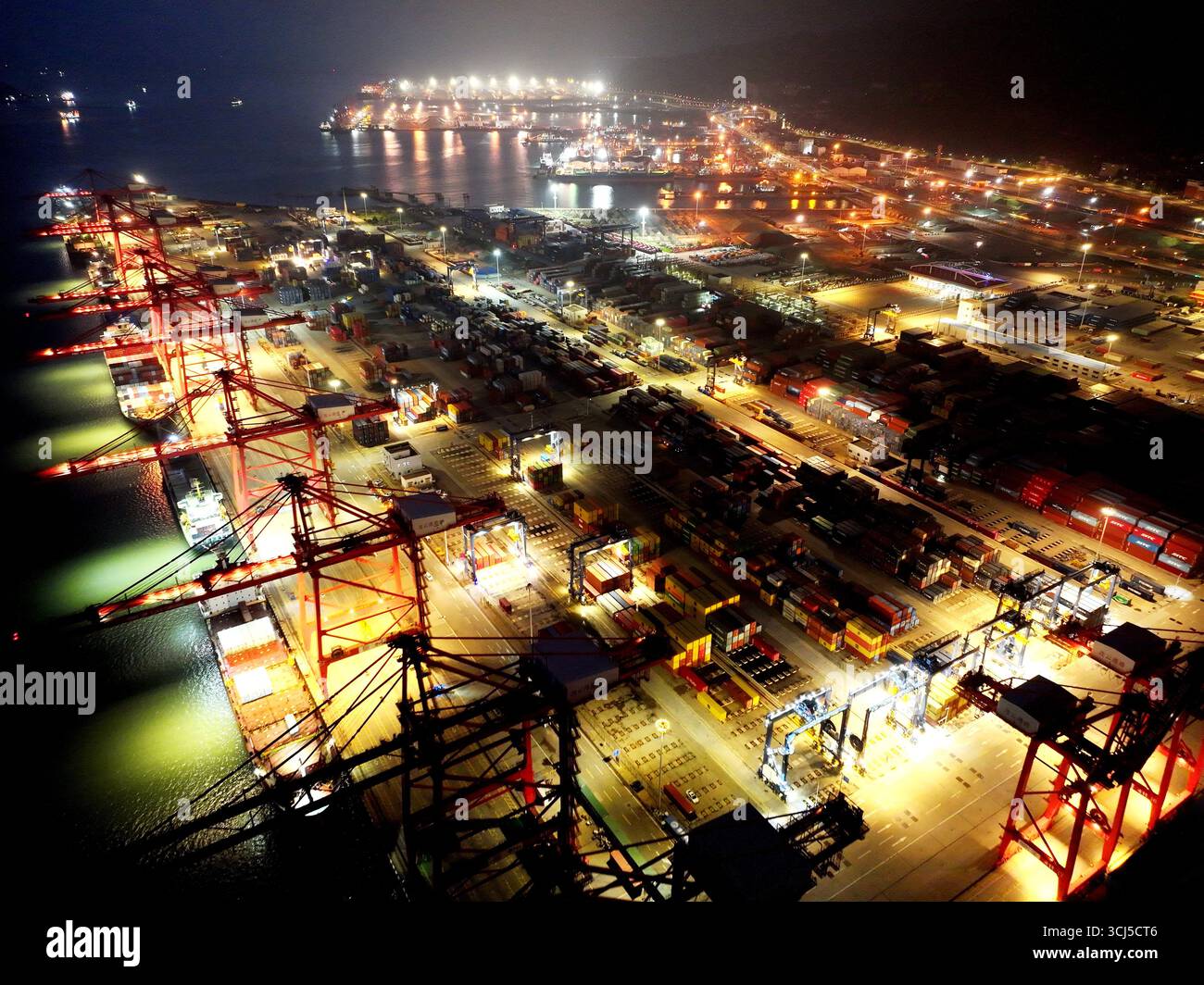 Aerial photo shows the container terminal of Lianyungang Port at night ...