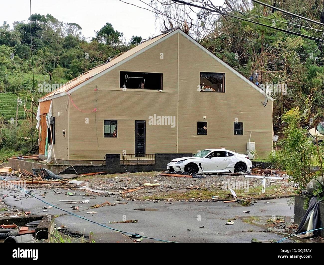 A photo shows a house damaged by a sudden gust of wind believed to be a ...