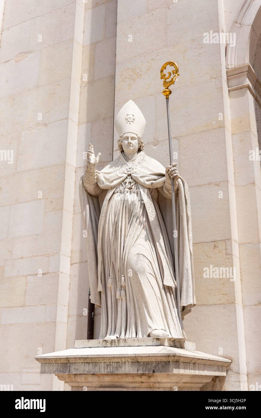 Statue of bishop with crosier in front of Salzburg Cathedral under ...