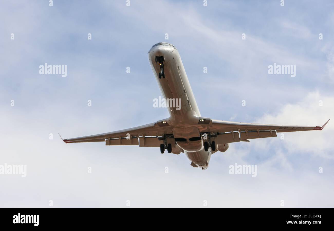 Modern passenger airplane is descending for landing with landing gear ...