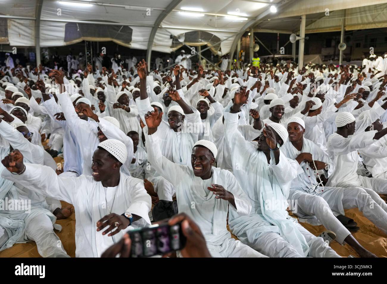 Men sing and gesture as they mark Prophet Muhammad's birthday, known as ...