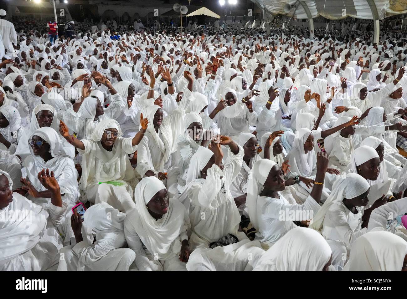 Women sing and gesture as they mark Prophet Muhammad's birthday, known ...