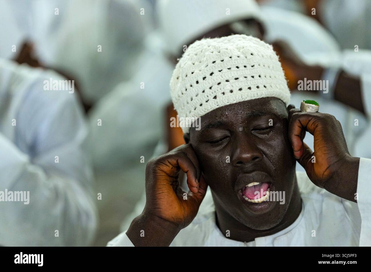 A man recites prayers as people mark Prophet Muhammad's birthday, known ...