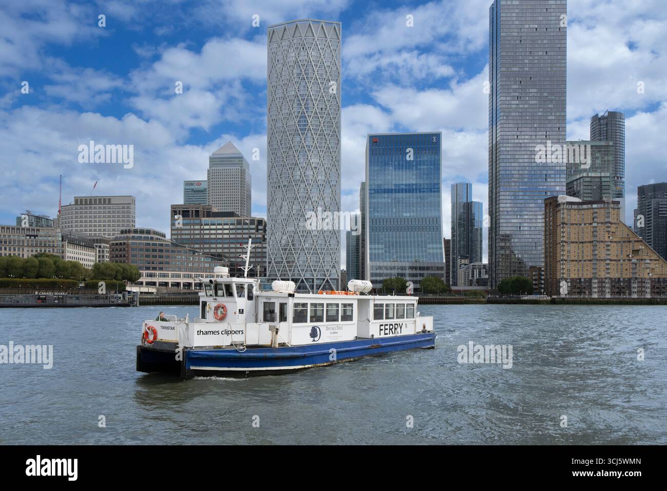 Thames Clippers ferry navigates the River Thames in London's Canary ...