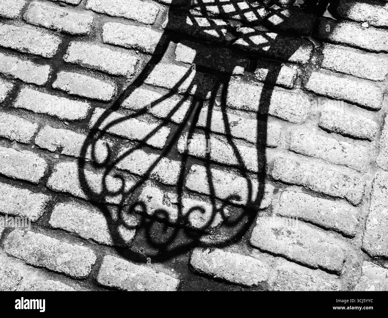 Shadow cast on cobbled street Black and White Stock Photos & Images - Alamy