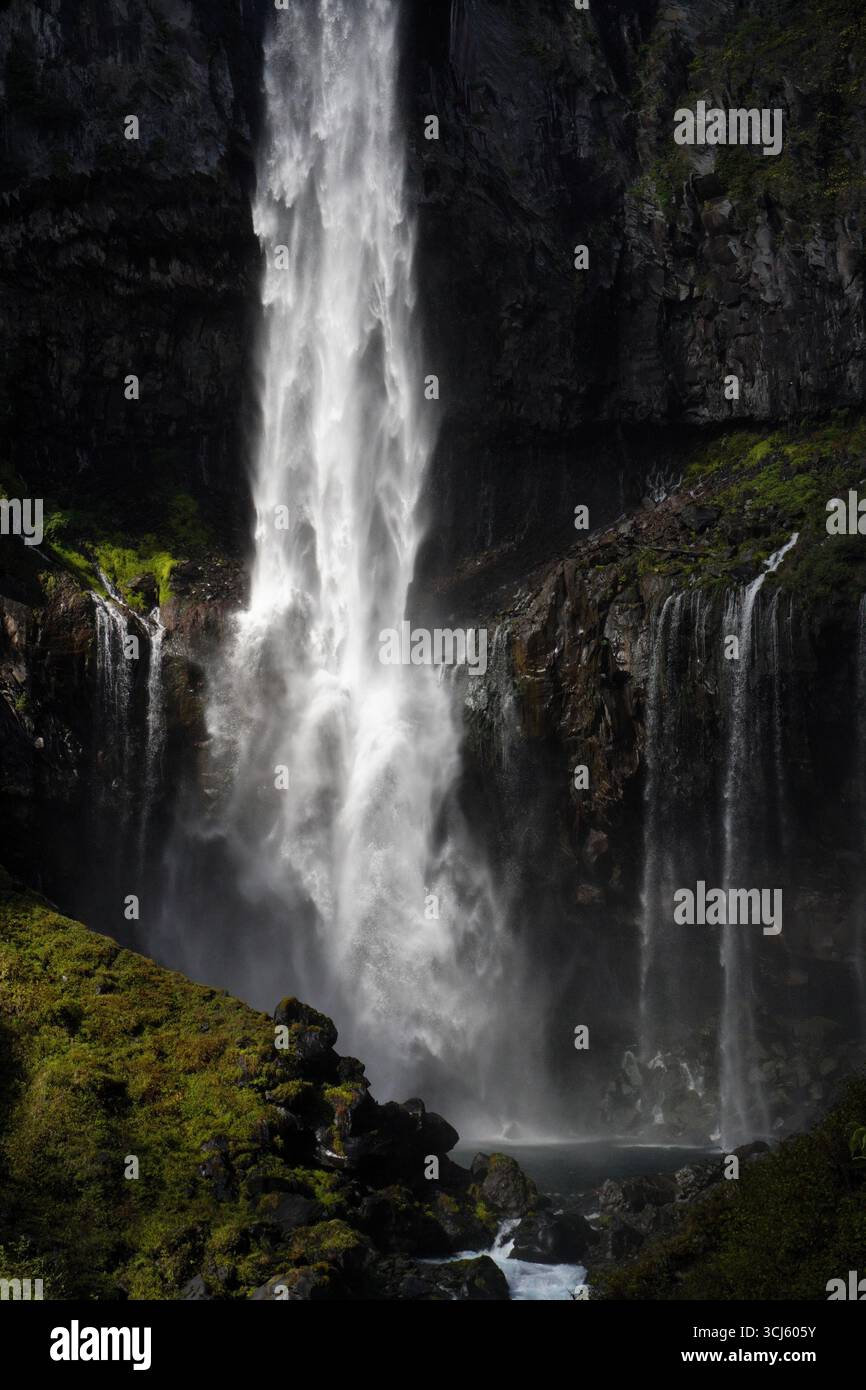 Beautiful strong waterfall coming down the massive rocky mountain of ...