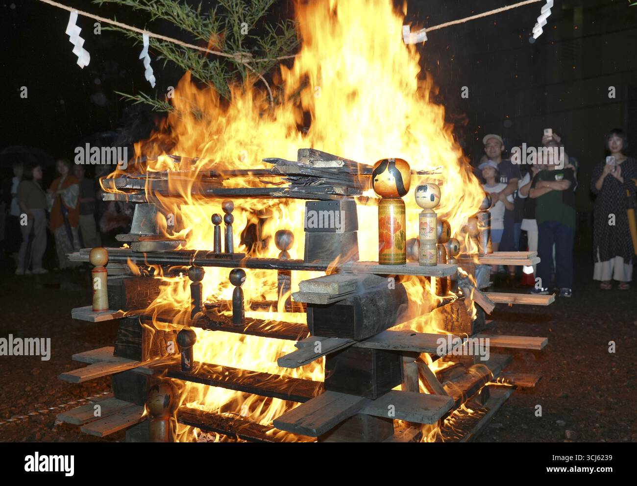 "Kokeshi" dolls no longer in use are burned during a "memorial service ...