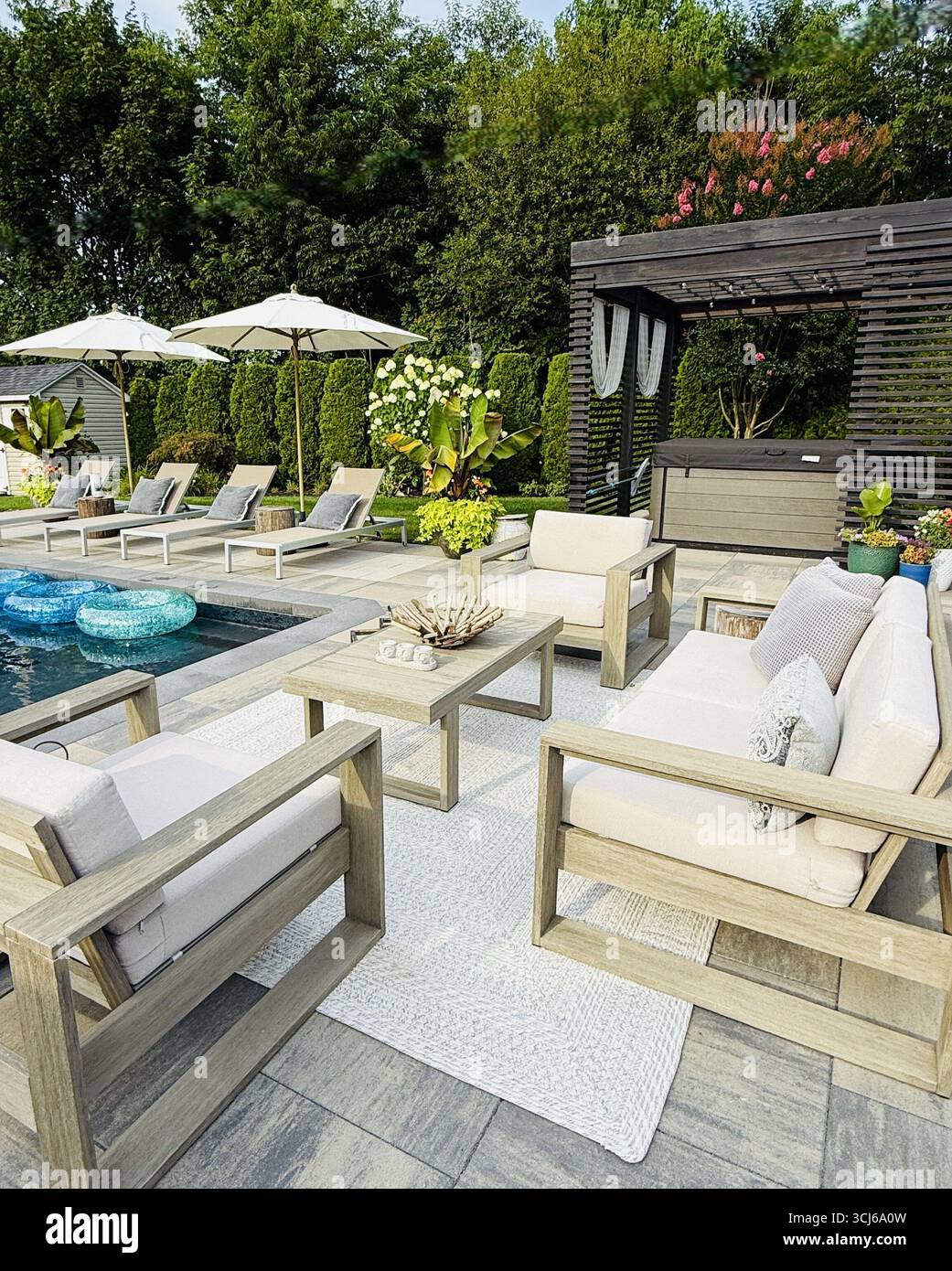 Luxury, modern design backyard pool patio lounge area. Umbrella, sofa ...