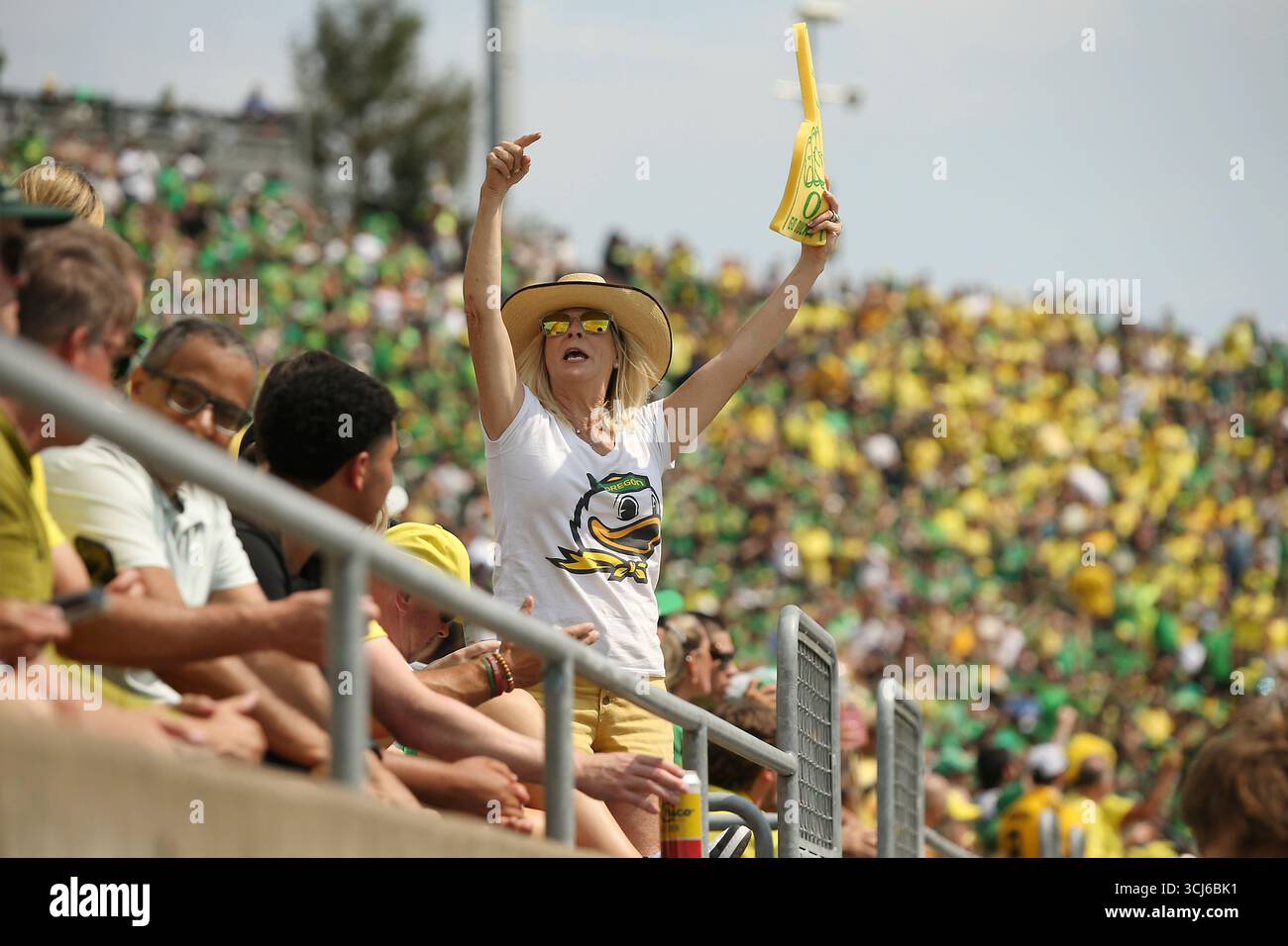 An Oregon fan cheers during the first half of an NCAA college football ...