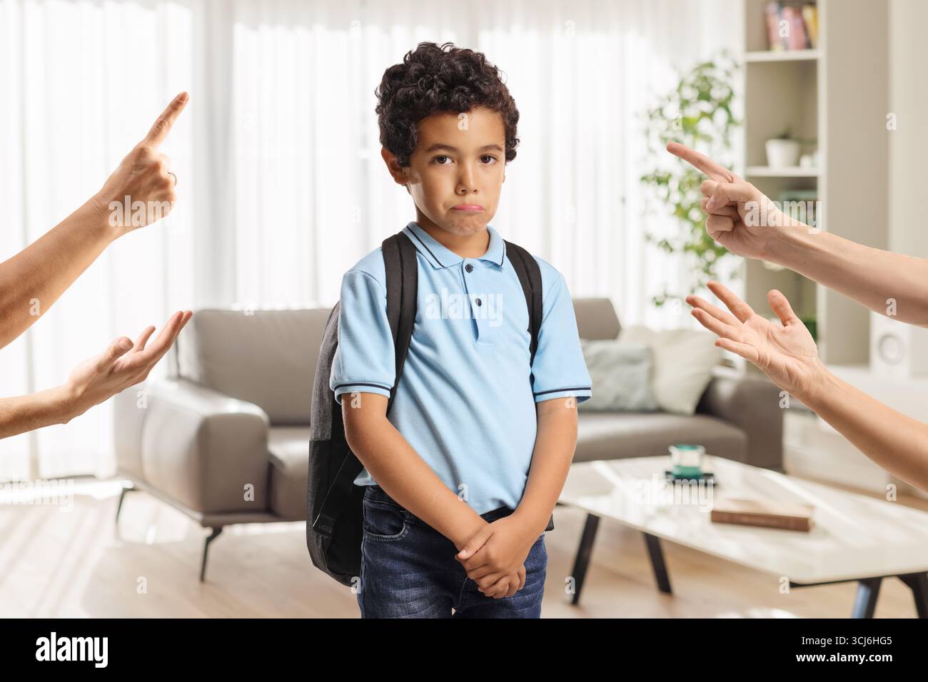 Sad kid in a room with hands around scolding and accusing Stock Photo ...