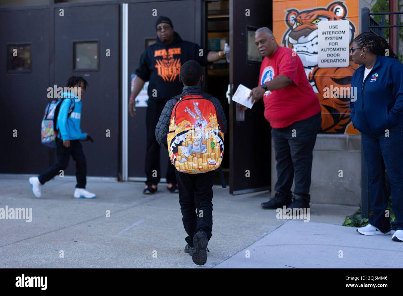 Students are guided inside as they arrive for school at Nash Elementary ...