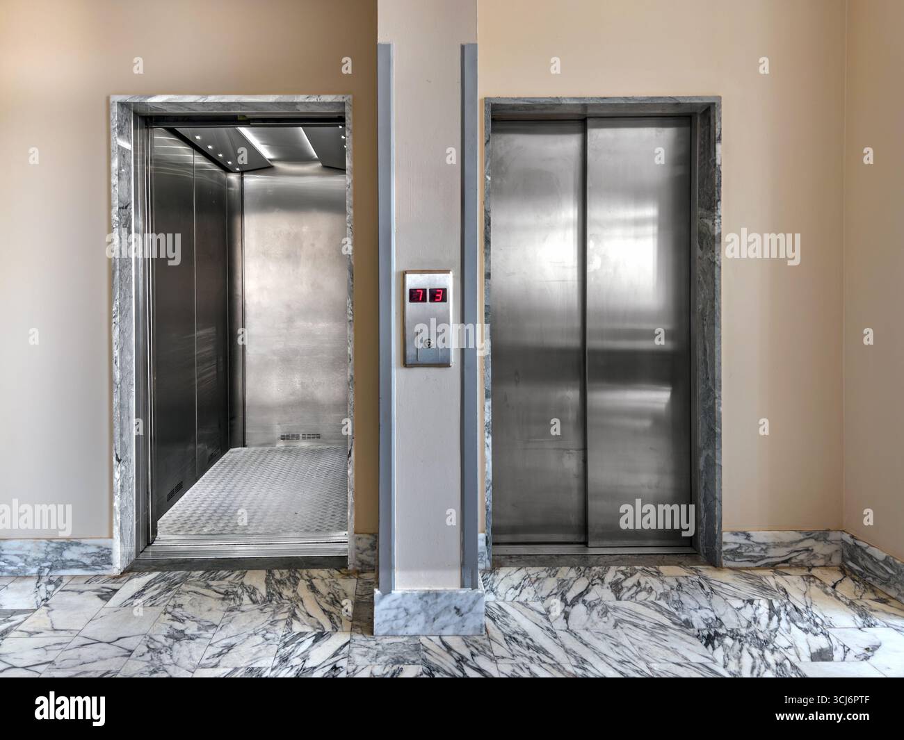 Two stretcher elevators, one lift enclosed with stainless steel doors ...