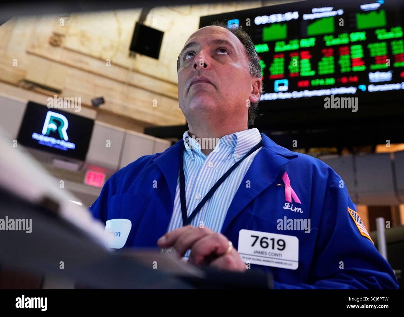 Trader James Conti works on the floor of the New York Stock Exchange ...