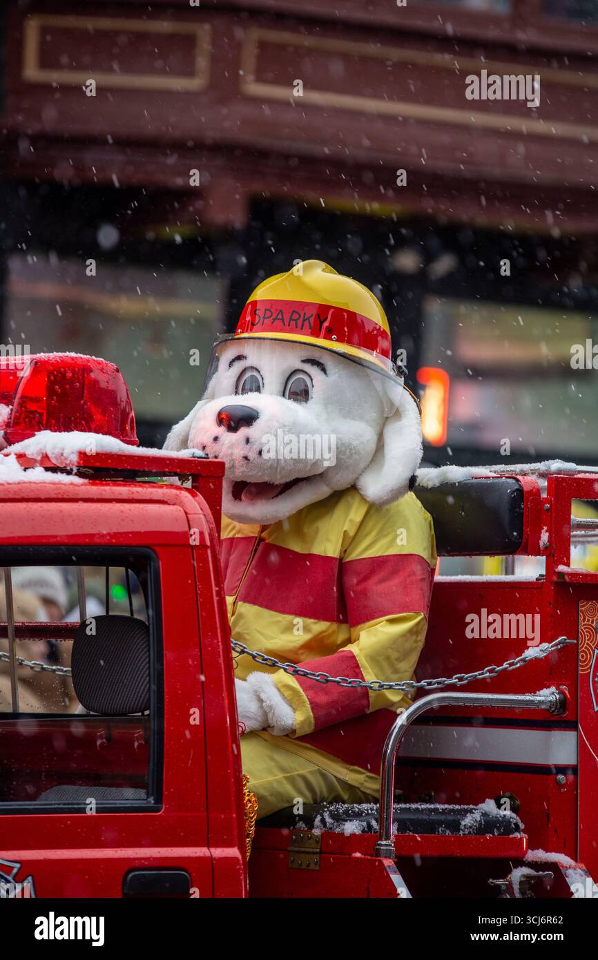Sparky the Fire Dog mascot riding a fire truck during Vancouver parade ...