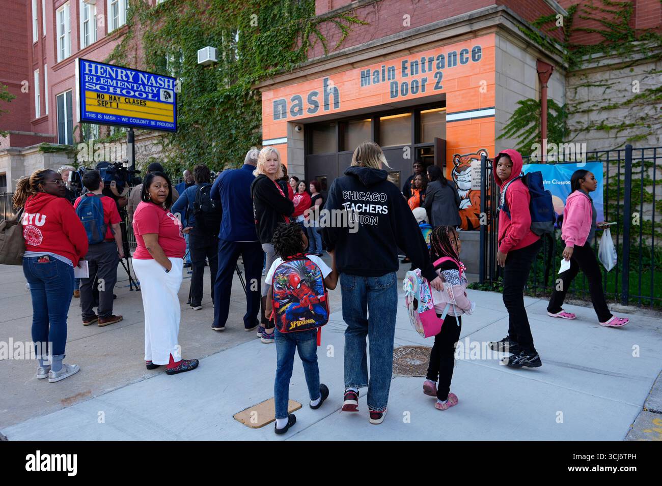 Students are guided inside as they arrive for school at Nash Elementary ...