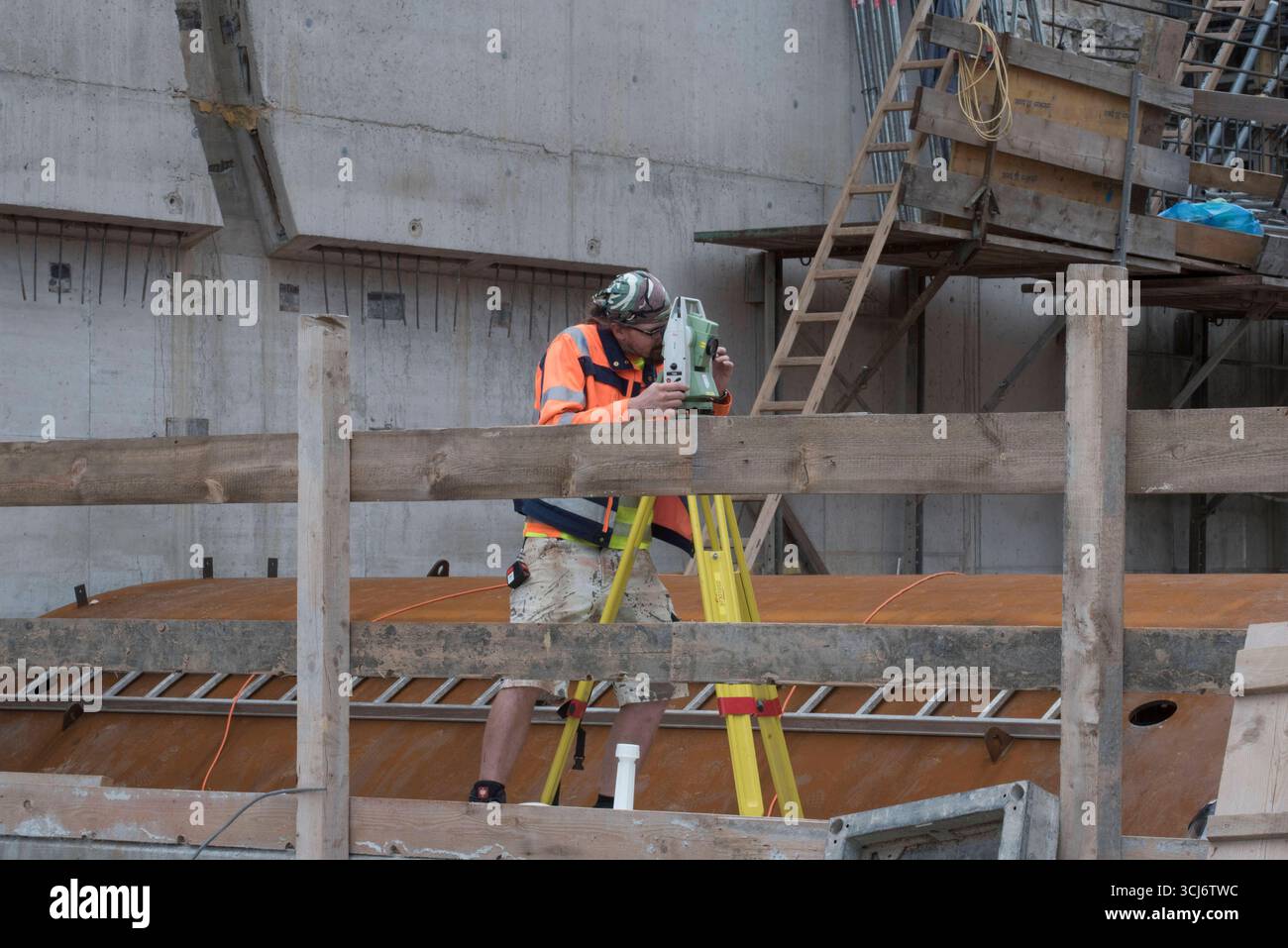 surveying by a land surveyor with measure instruments in geodesy ...