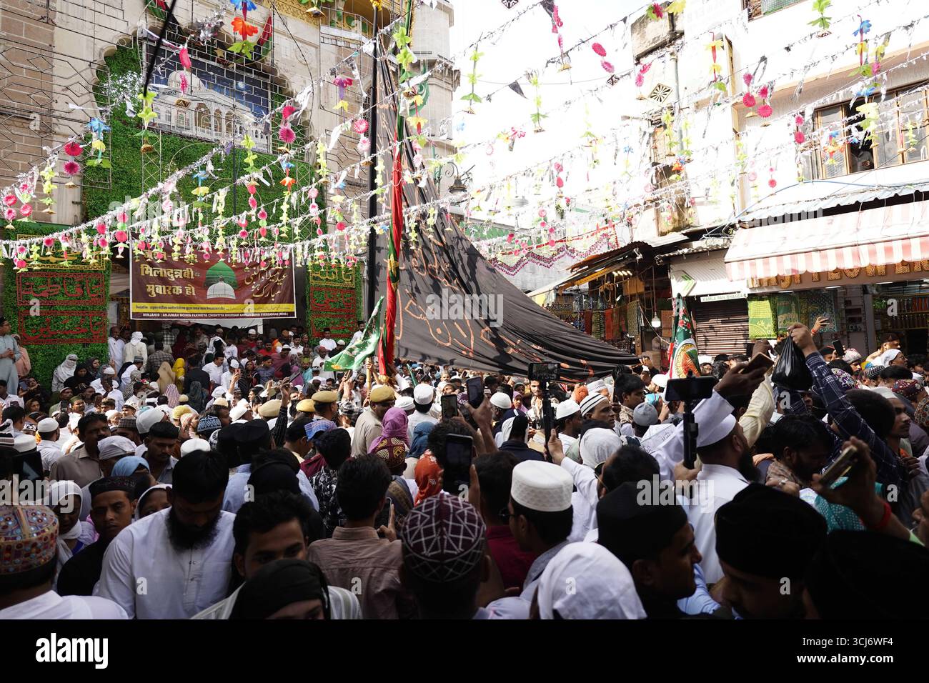 Indian Muslims hold Islamic flags as they take part in a religious ...