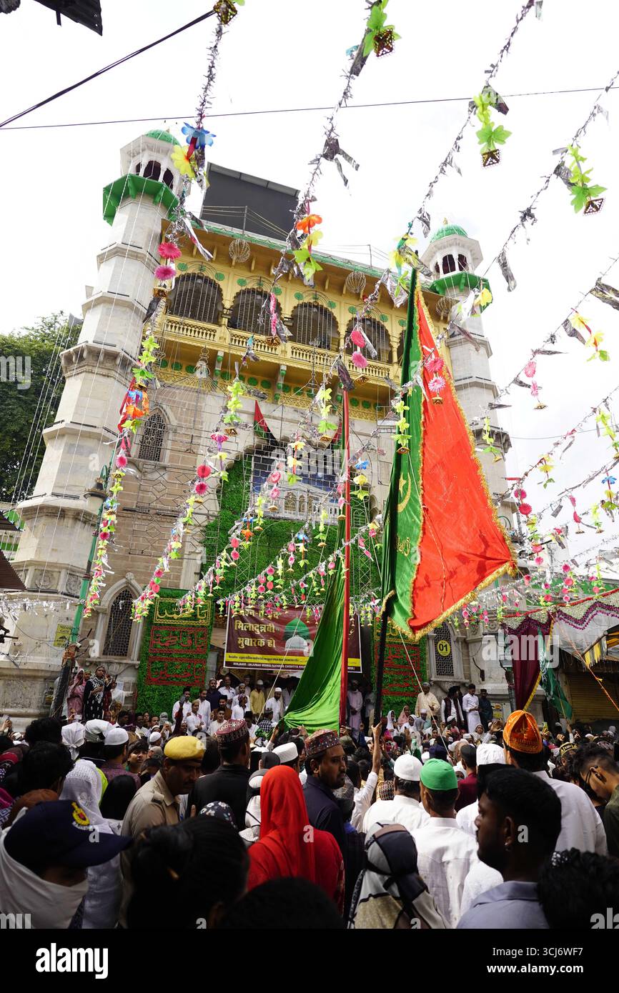 Indian Muslims hold Islamic flags as they take part in a religious ...