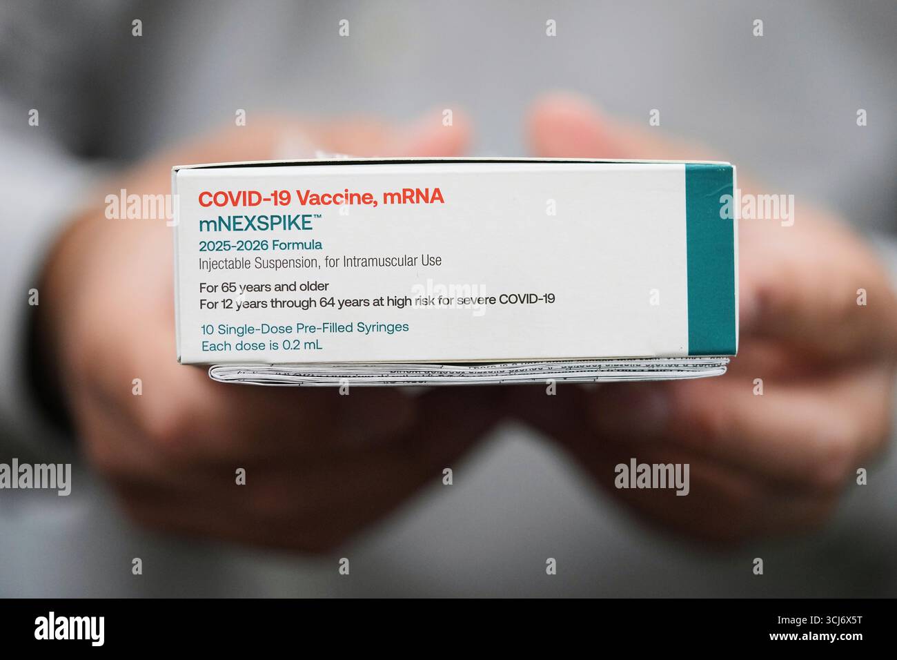 Co-owner Marc Ost at Eric's Rx Shoppe holds a box of COVID-19 vaccines ...