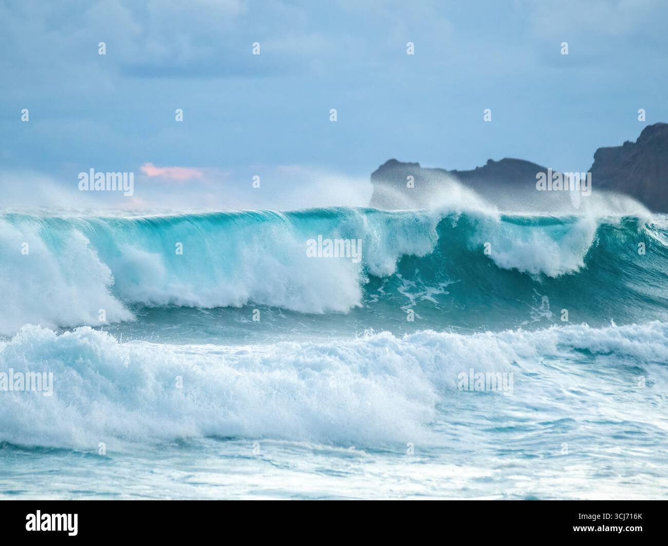 Giant waves crashing down with a winter storm on the horizon Stock ...