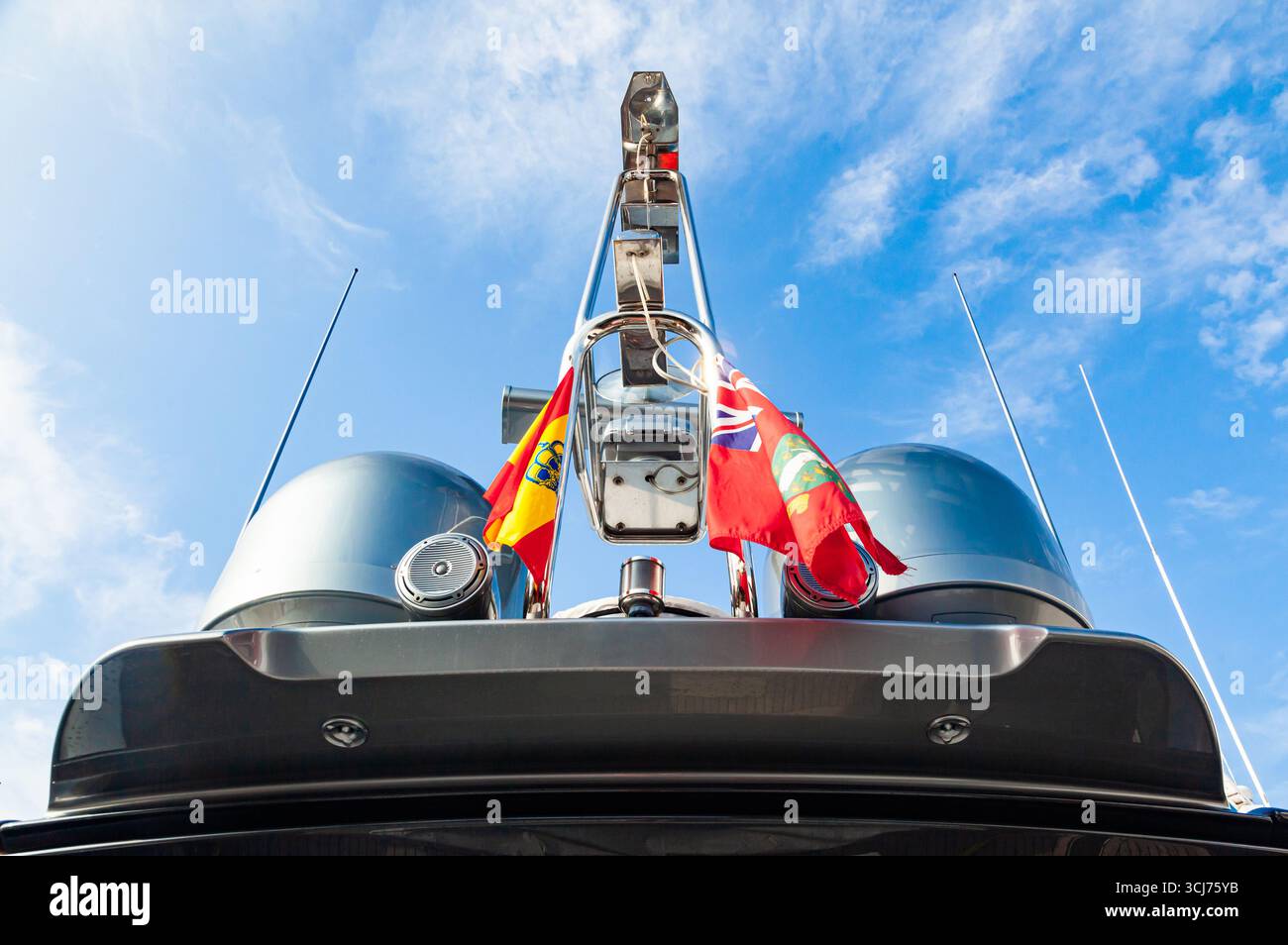 Large mast of a yacht with navigational equipment, view from below ...